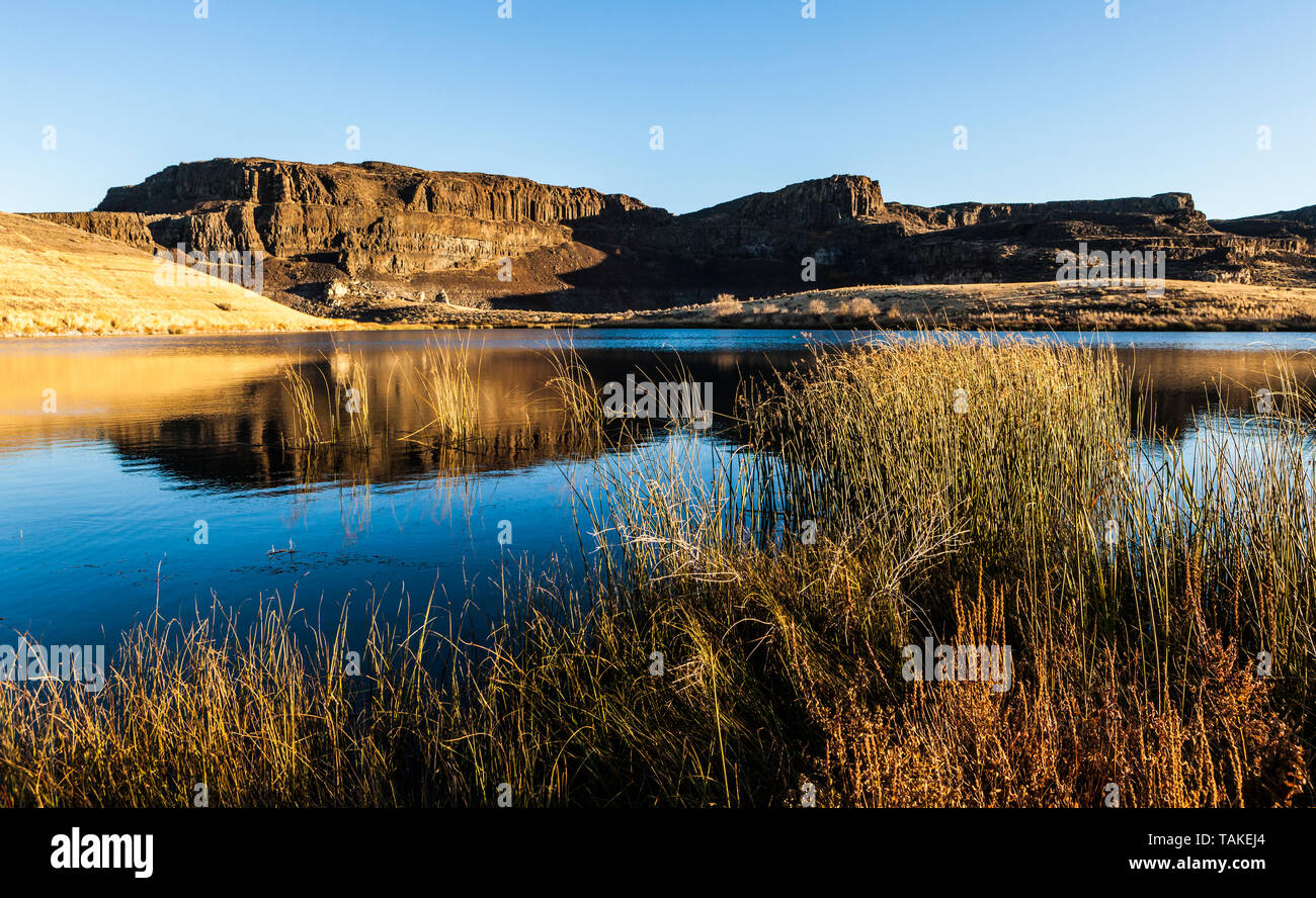 A view of the shoreline and cliffs above Ancient lake in Potholes ...