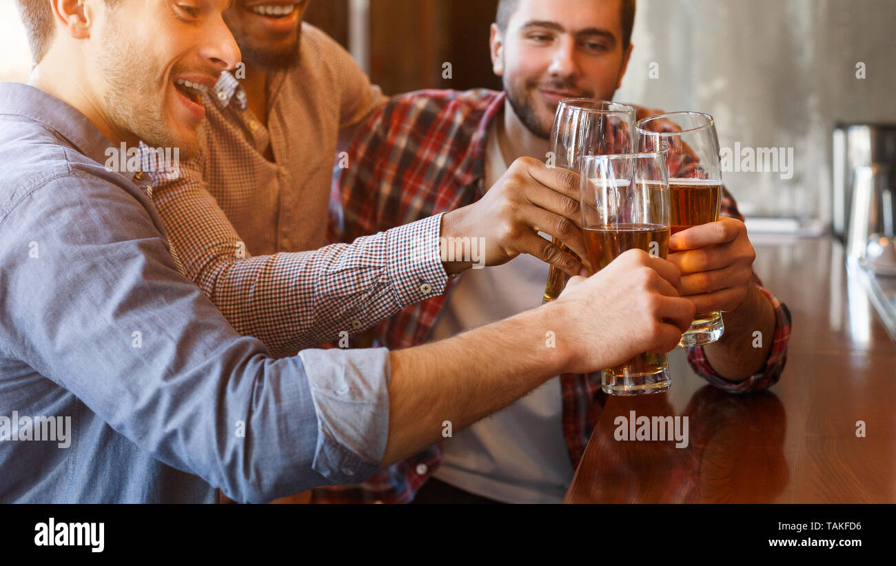 Cheers, Friends. Men Drinking Beer And Clinking Glasses Stock Photo - Alamy