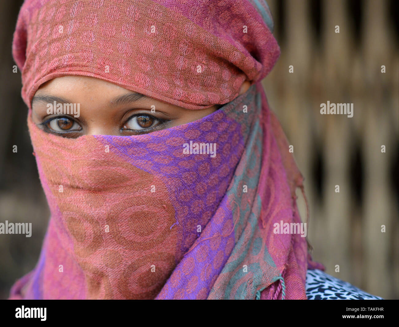 Brown-eyed Indian Rajasthani scooter girl covers her face with a ...