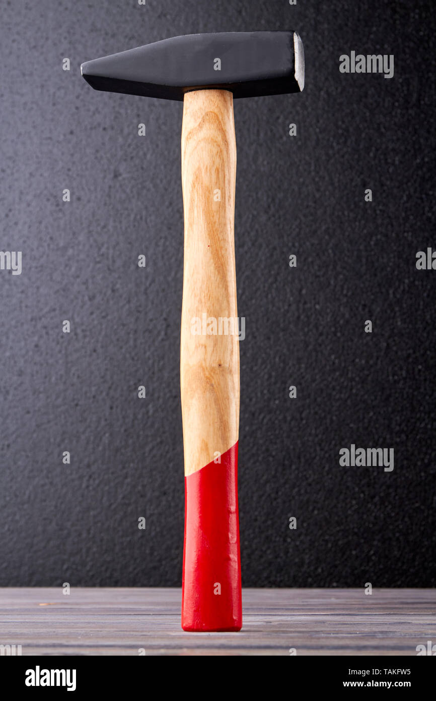 Metal hammer with red handle. Construction tool on dark background ...