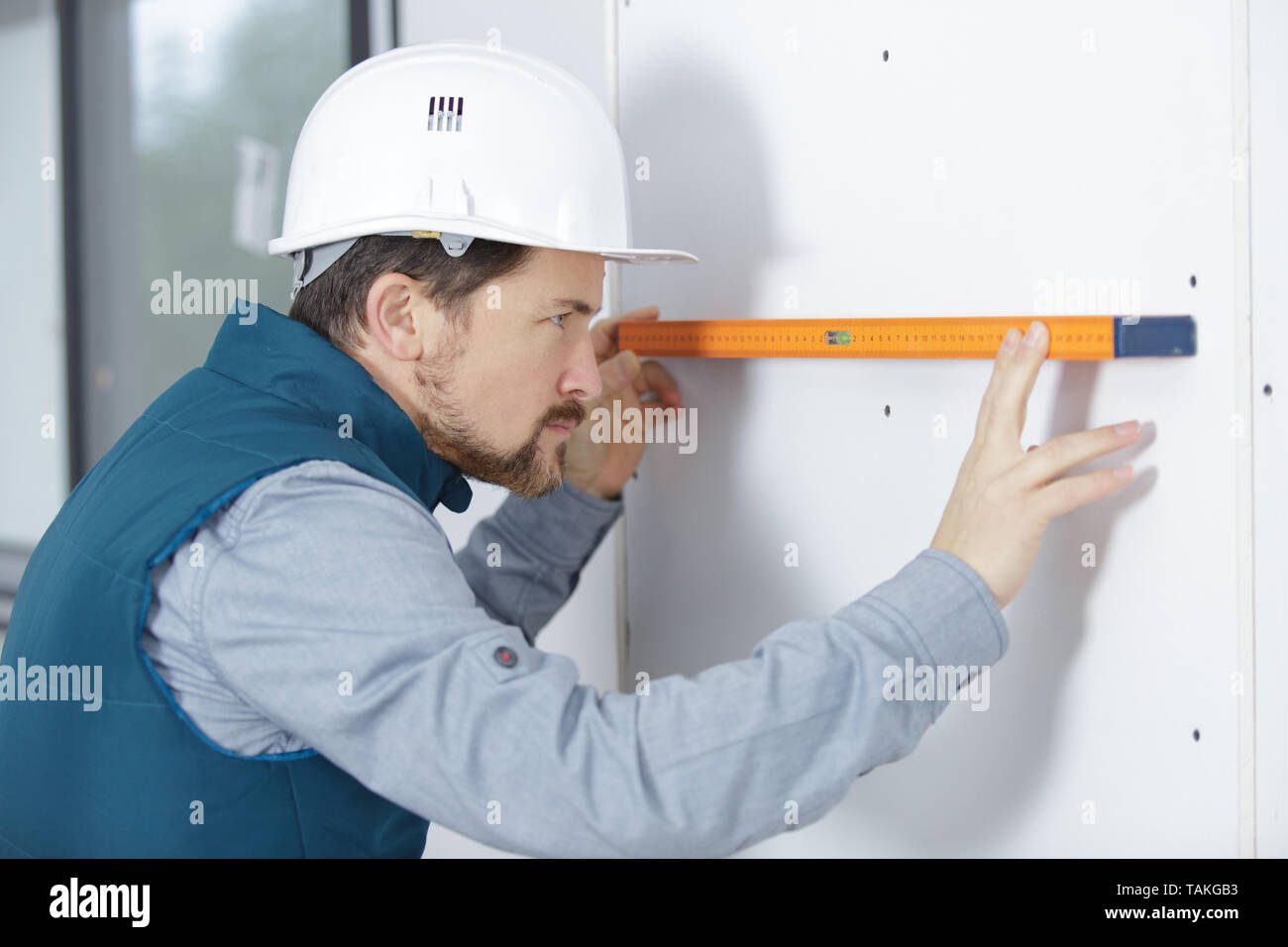 Happy young builder measuring hi-res stock photography and images - Alamy