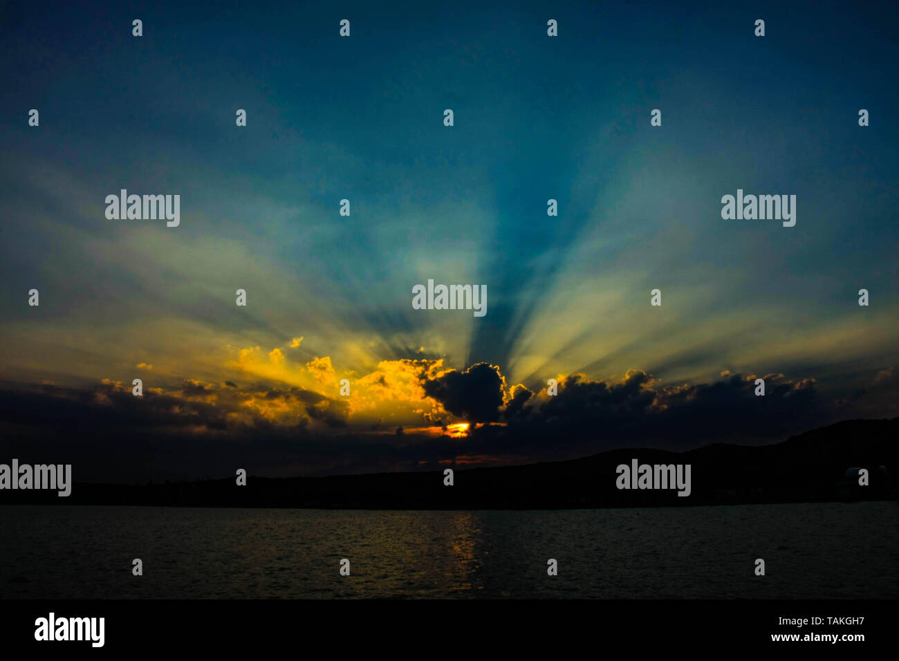 Beautiful, colorful sunshine, sunset sunbeams, sun ray on the blue sky ...