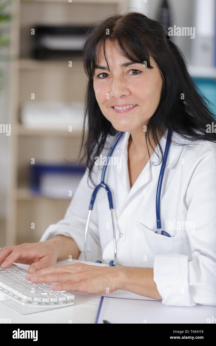 female doctor typing on laptop computer Stock Photo - Alamy