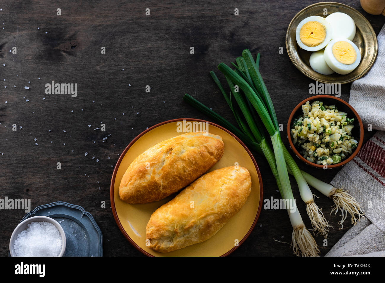 Traditional georgian pies with eggs, rice and green onion on dark ...