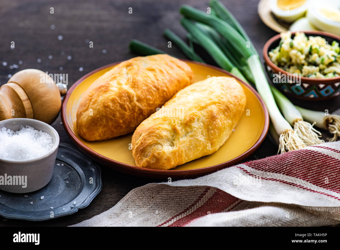 Traditional georgian pies with eggs, rice and green onion on dark ...