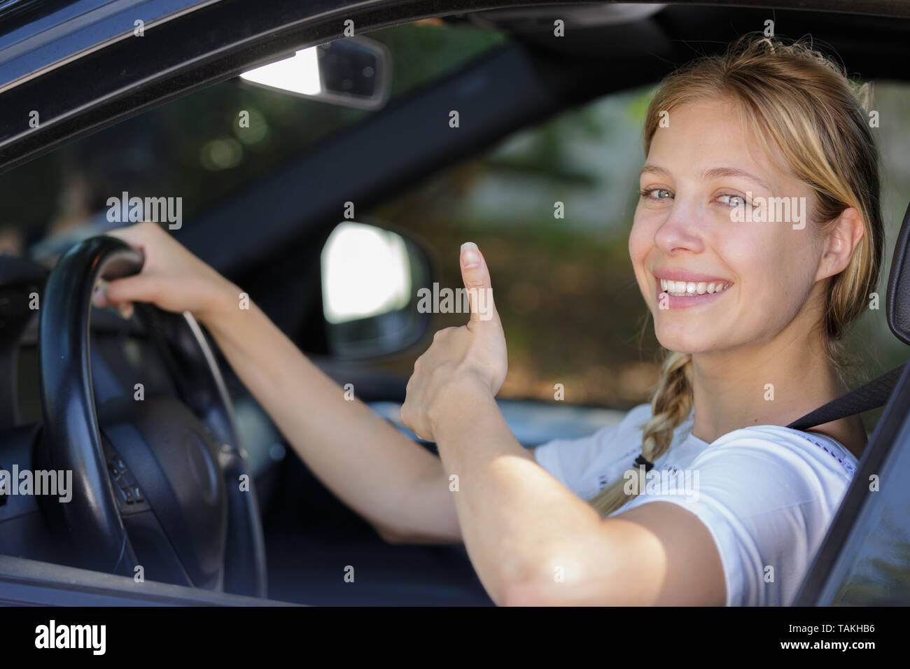beautiful smiling girl with thumbs up signal of victory Stock Photo - Alamy