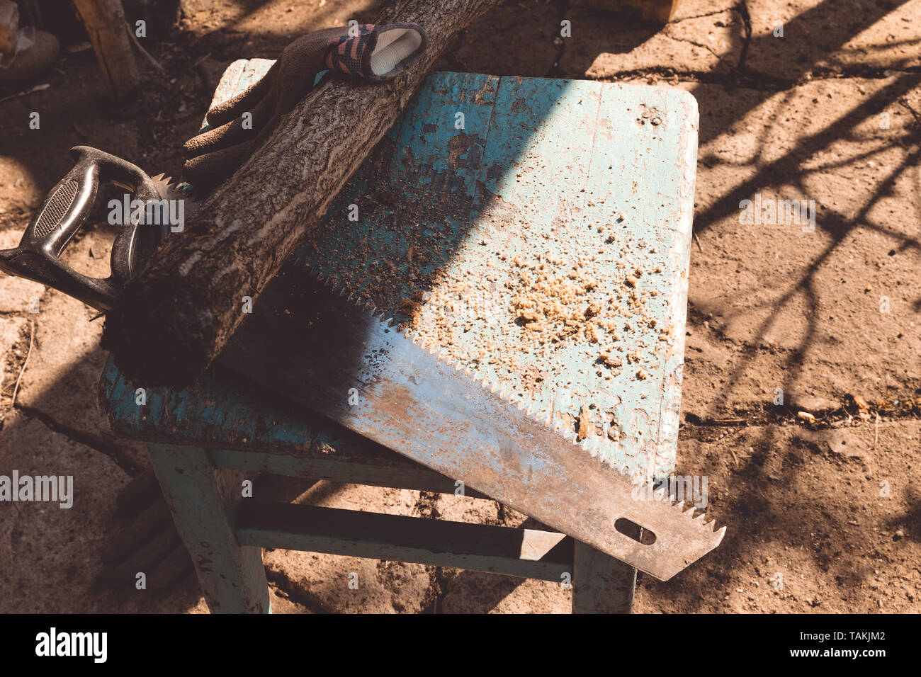 Working tool for pruning trees. Saw lies on a stool with sawdust Stock ...