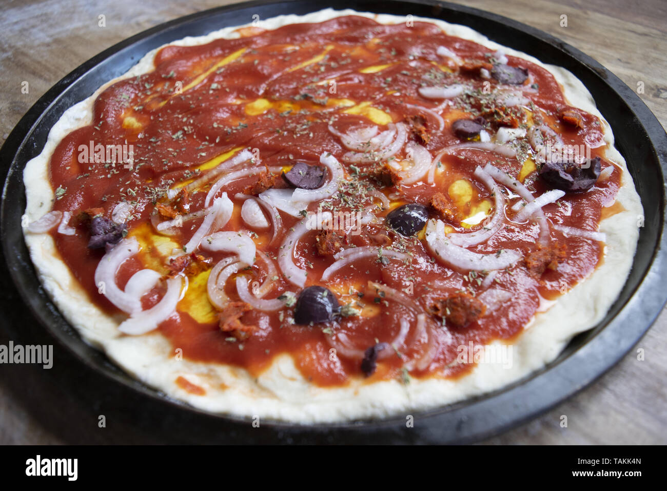 homemade red pizza with onion of tropea and black olives Stock Photo ...
