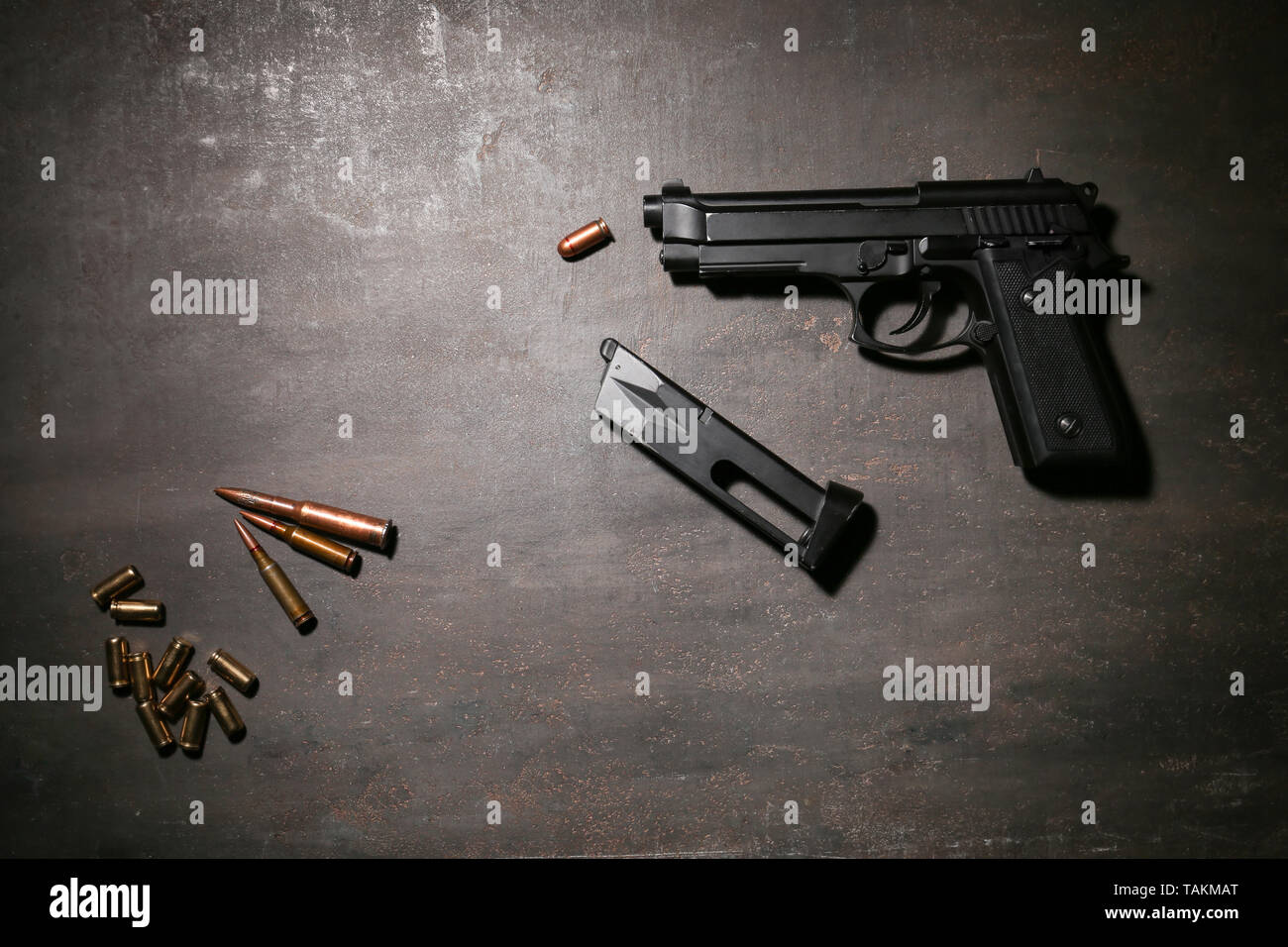 Gun with bullets on grey background Stock Photo - Alamy