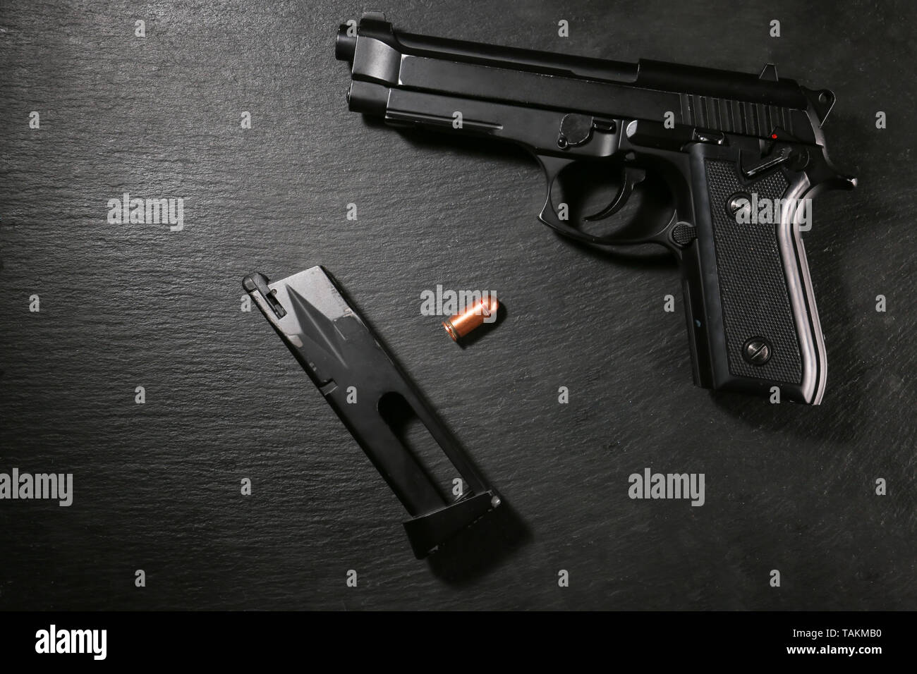 Gun with bullet and magazine on grey background Stock Photo - Alamy