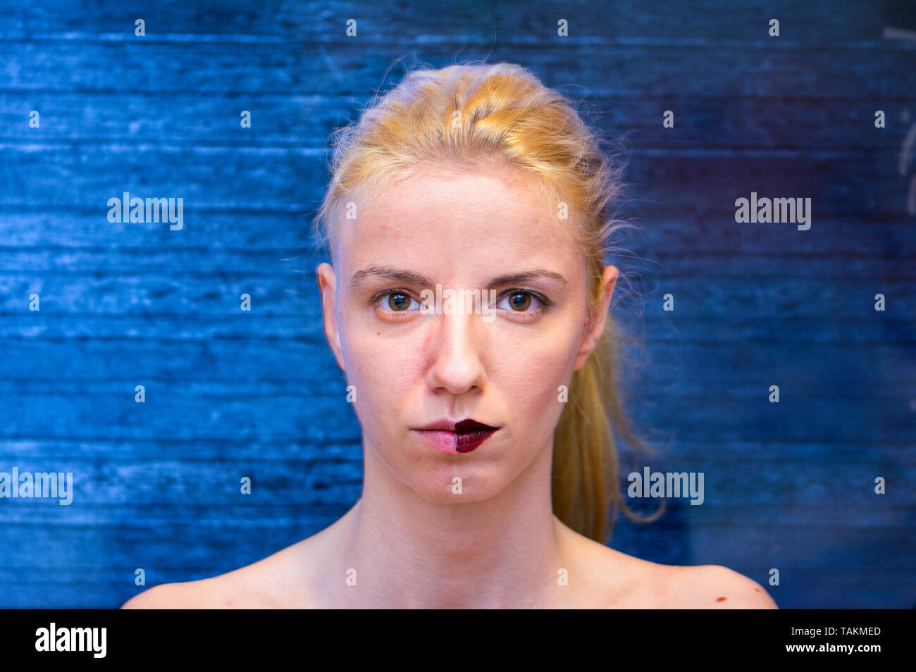 A girl with half of her face with make-up while the other is natural ...