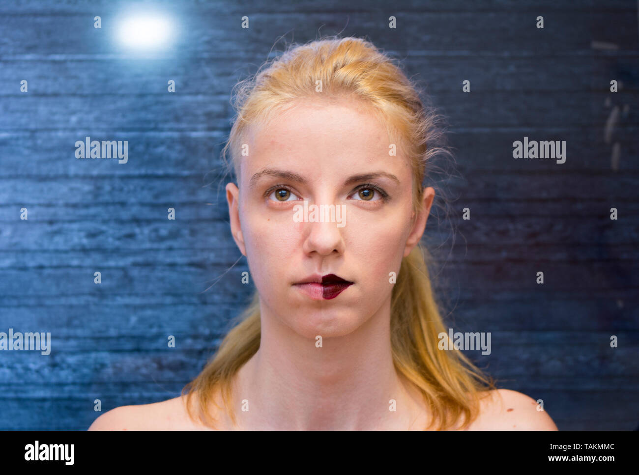 A girl with half of her face with make-up while the other is natural ...