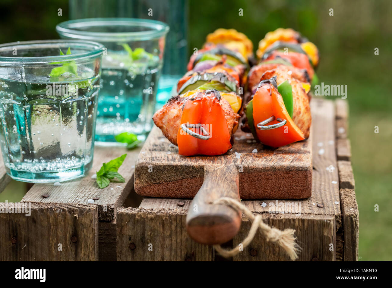Homemade grilled skewers served with water in hot summer Stock Photo ...