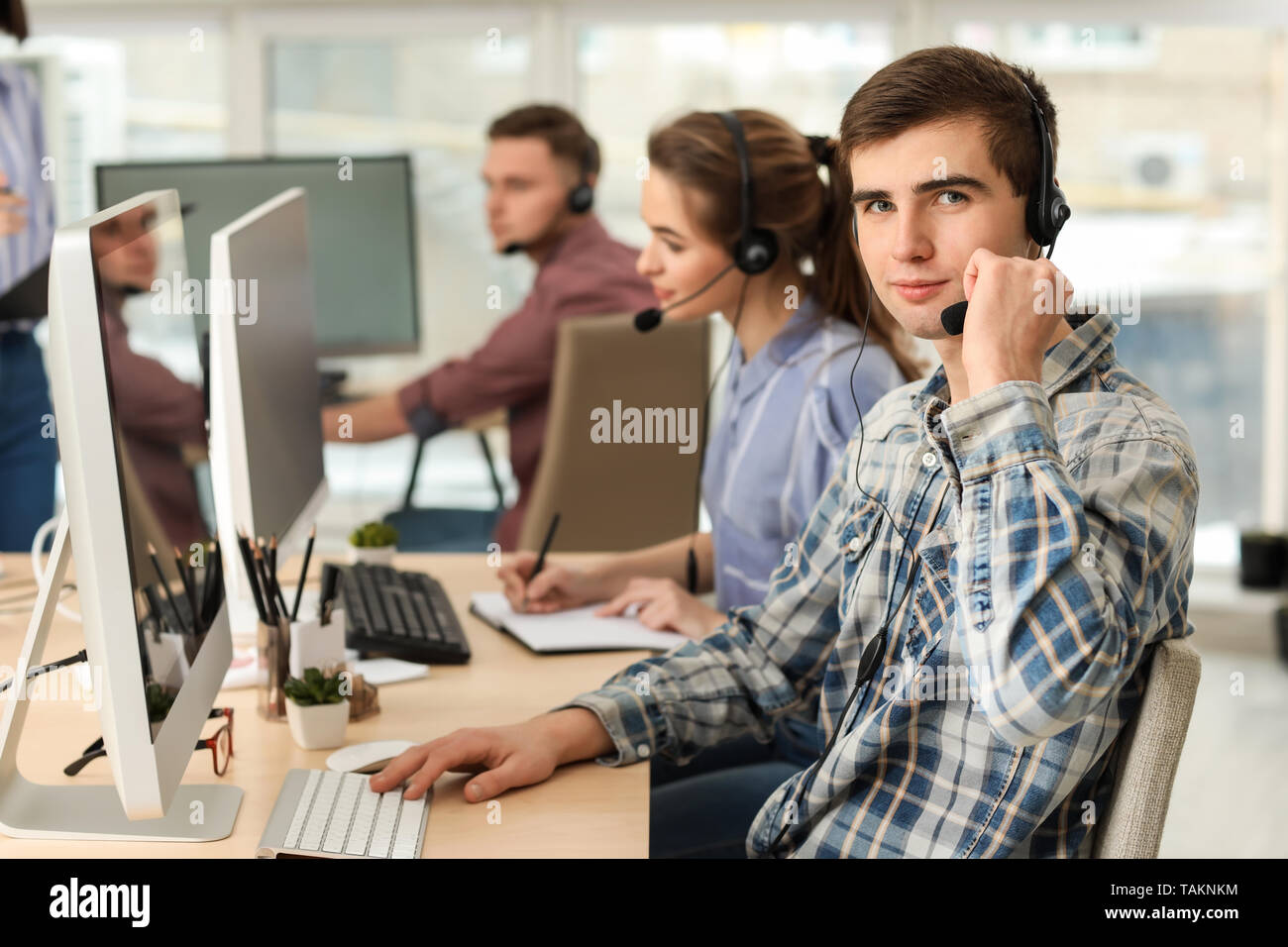 Technical support agents working in office Stock Photo - Alamy