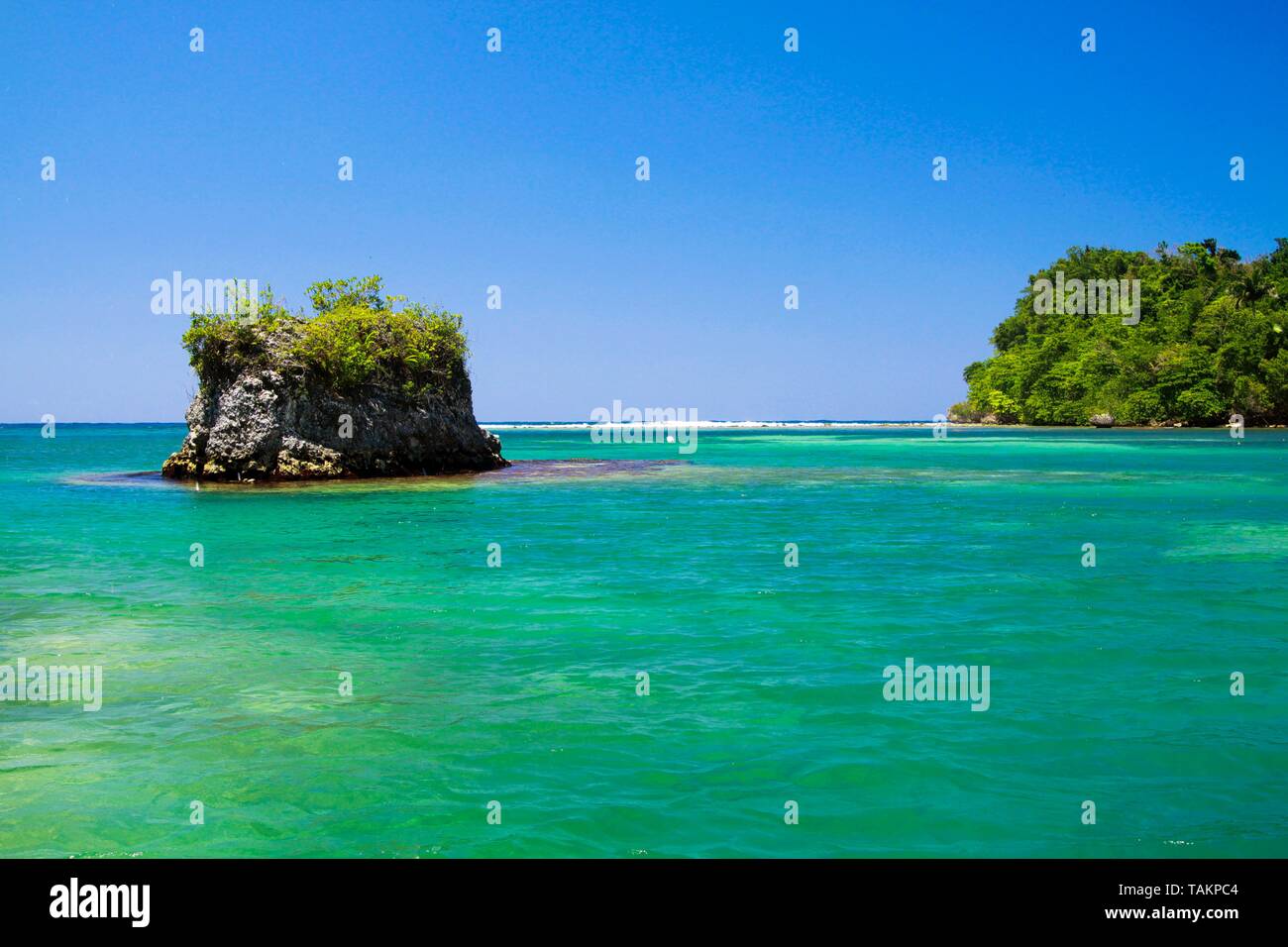 Isolated islet at reef in turquoise sea - Blue lagoon, Port Antonio ...