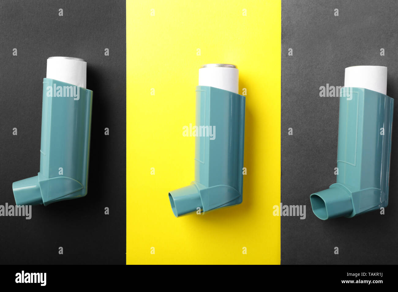 Inhalers on color background Stock Photo - Alamy