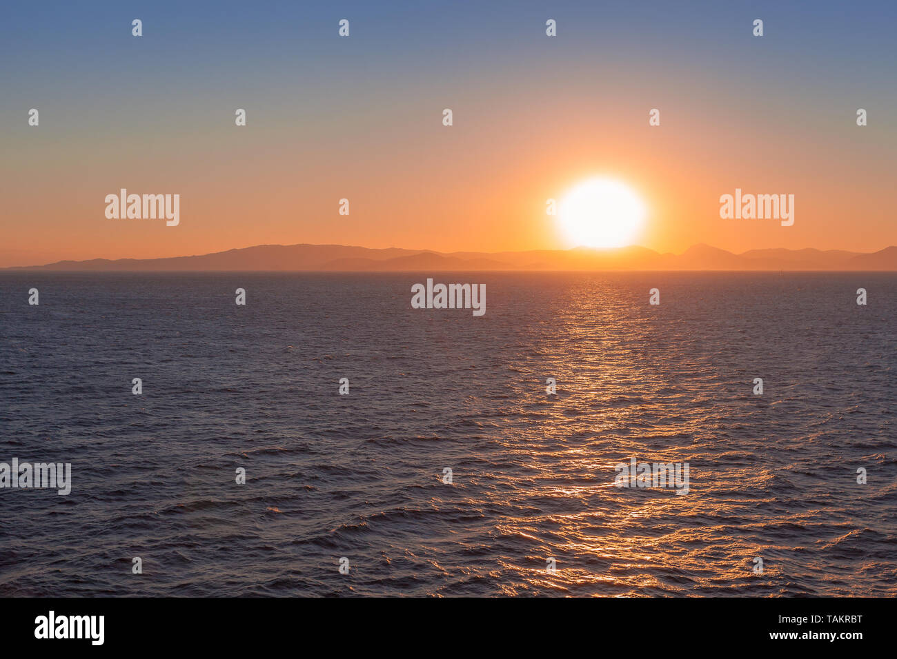 Beautiful sunset over the sea with islands of Saronic Gulf background ...