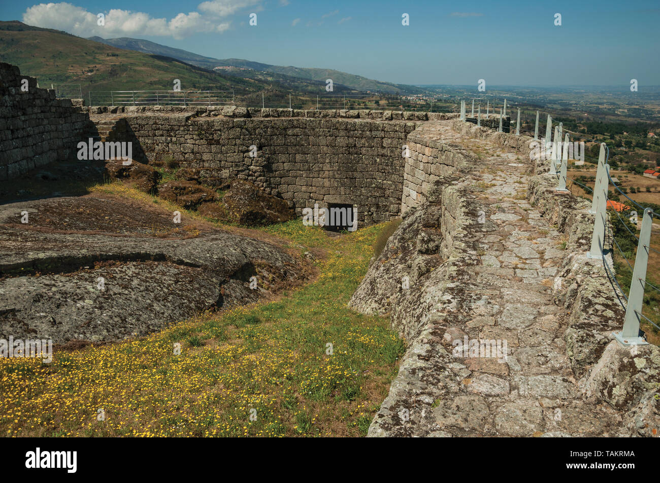 Wall in rocky courtyard and hilly landscape at the Linhares da Beira ...