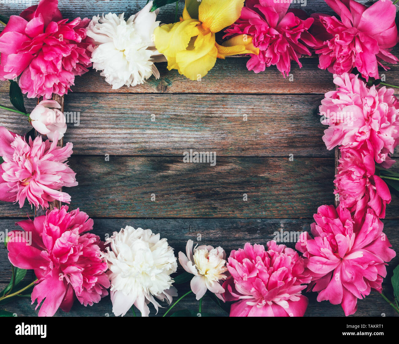 frame bouquet of pink and white peonies flowers close-up on wooden ...