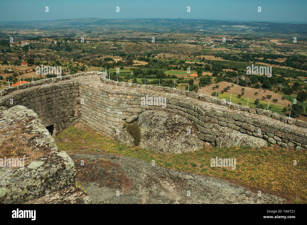 Wall in rocky courtyard and hilly landscape at the Linhares da Beira ...