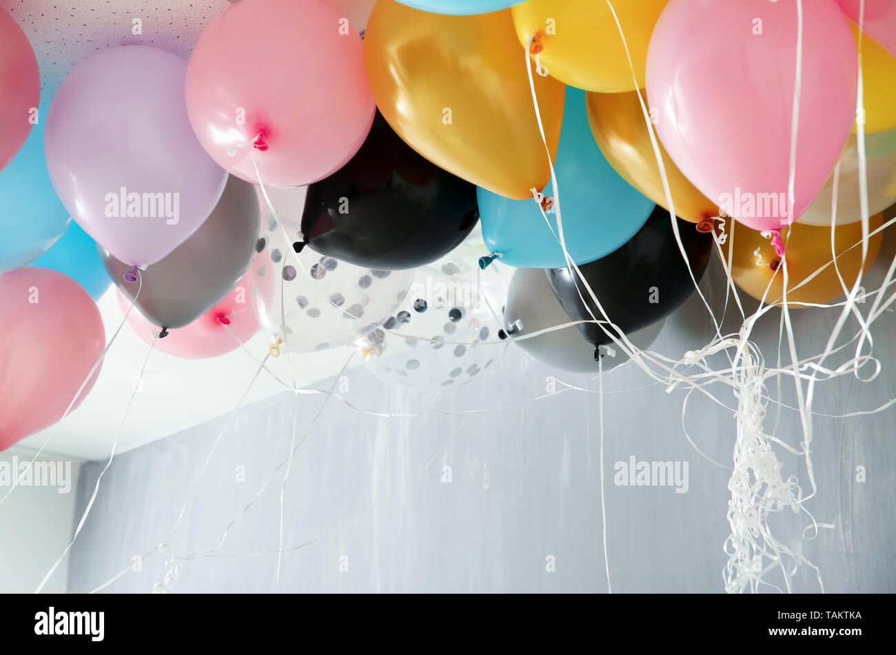 Many colorful balloons under ceiling in room Stock Photo - Alamy