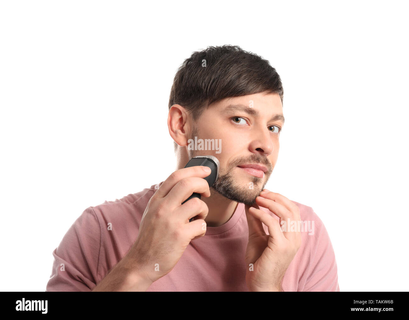 Handsome man using electric shaver against white background Stock Photo ...