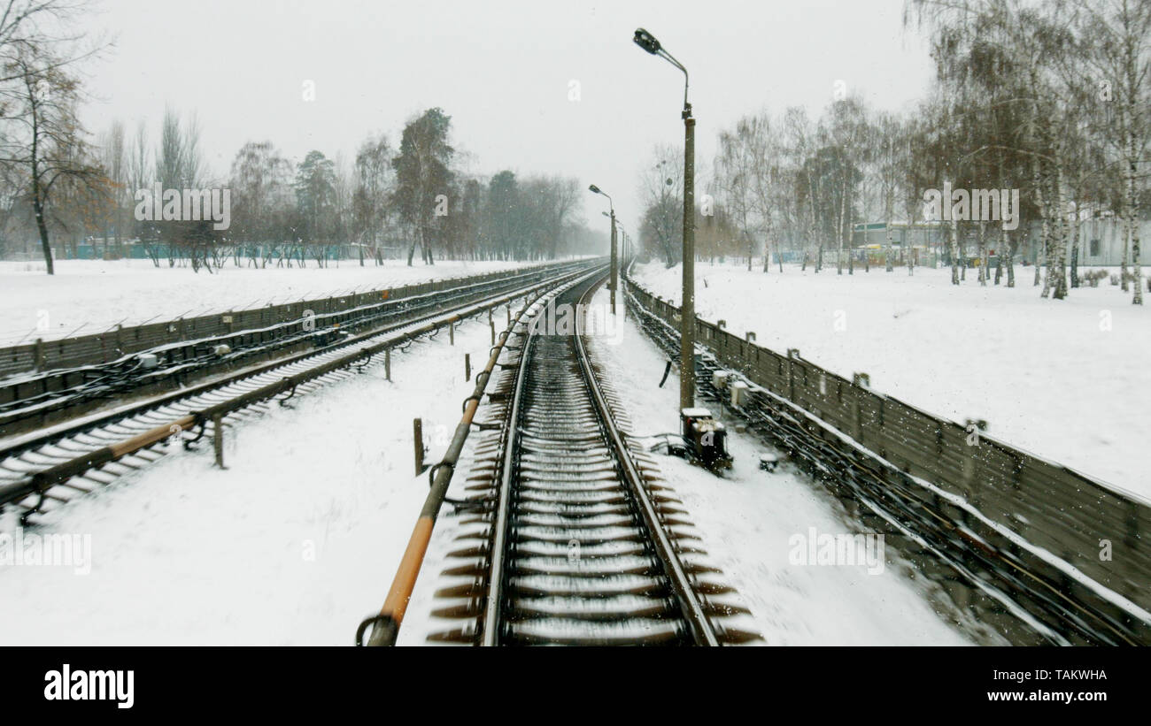 Railway in the winter. High-speed train goes in the winter season. Snow ...
