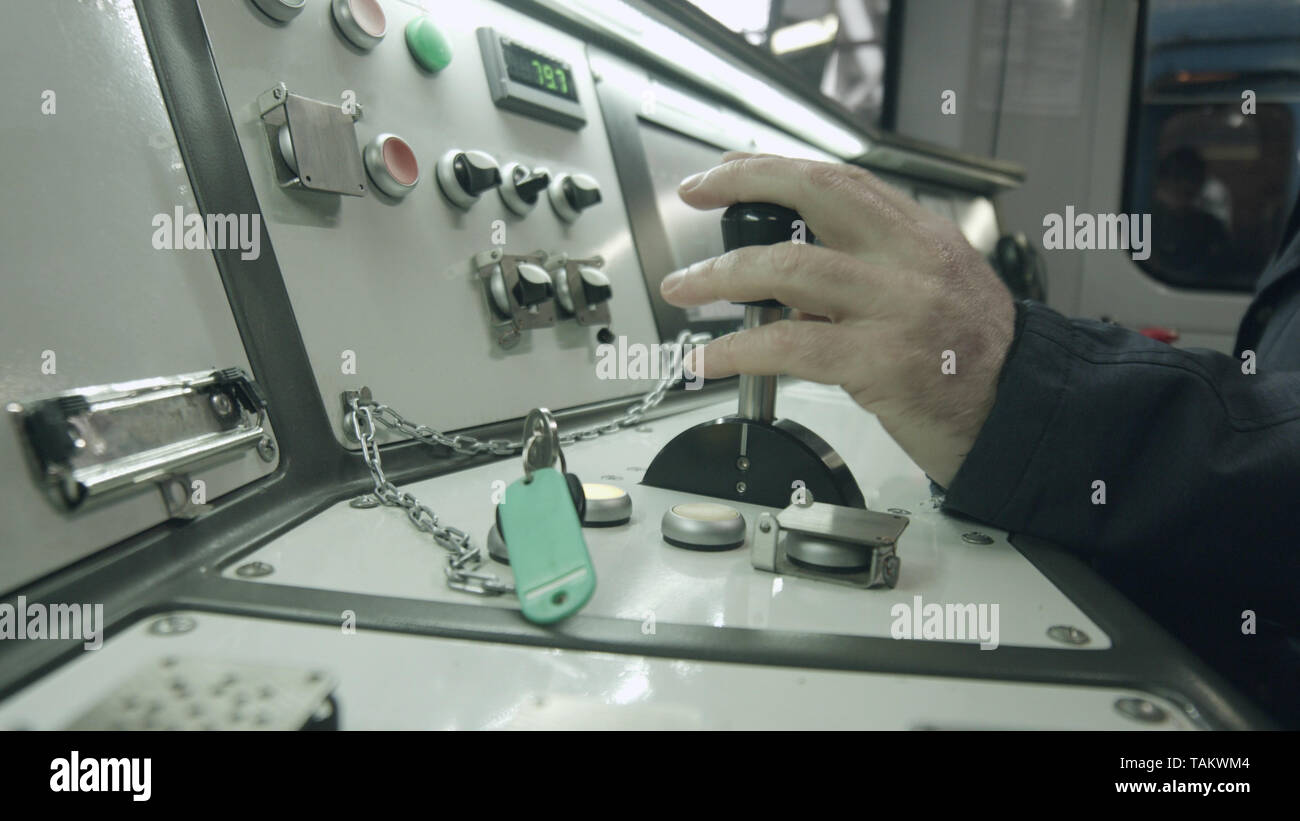 Interior view of the drivers cab high speed train. Train driver hand on ...