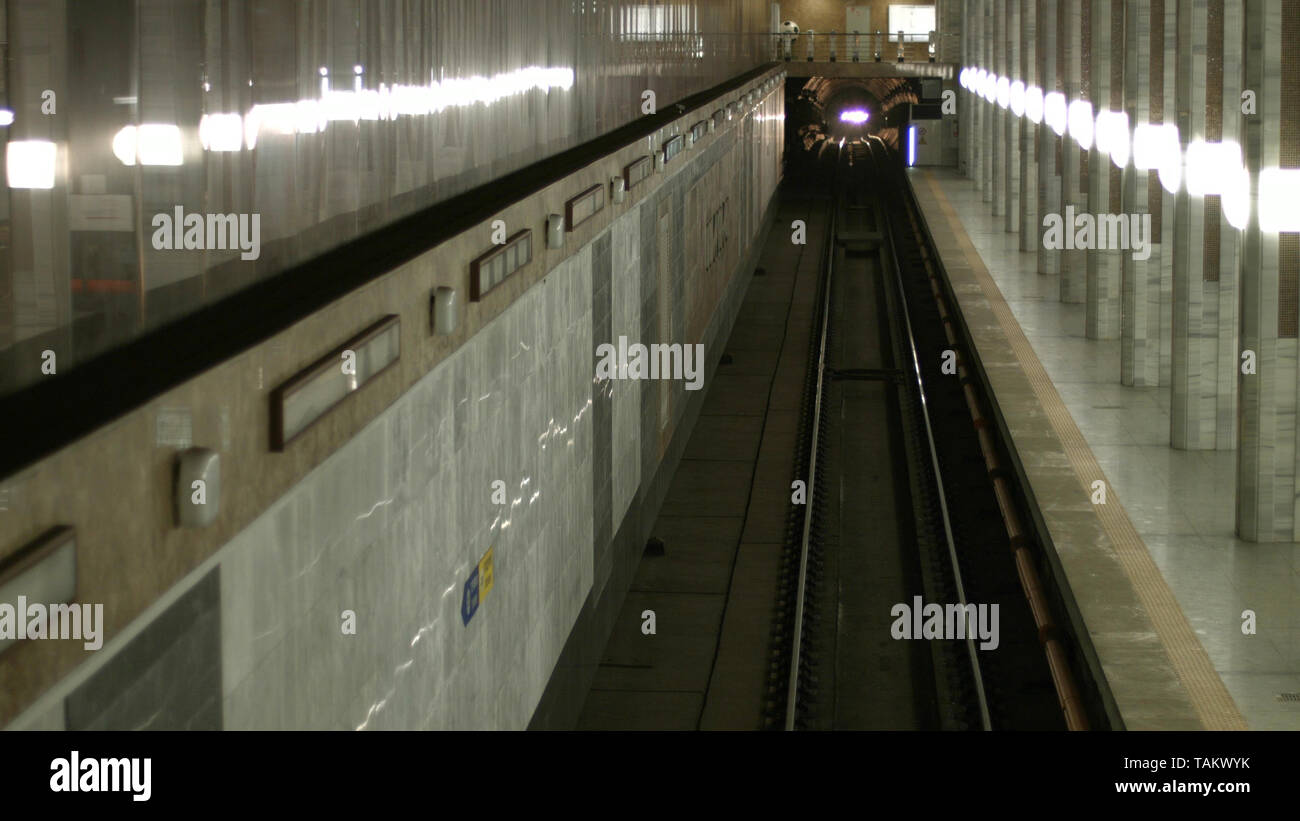 View of a subway tunnel. Underground train arriving at the station. LED ...