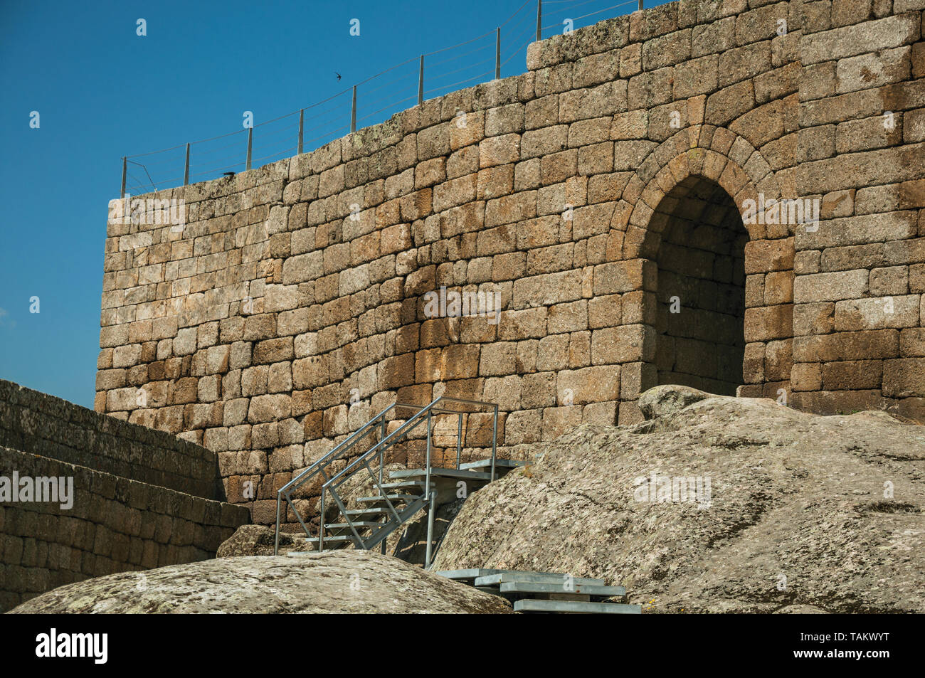Stone wall with gateway and stairs over rocky hill at the Linhares da ...
