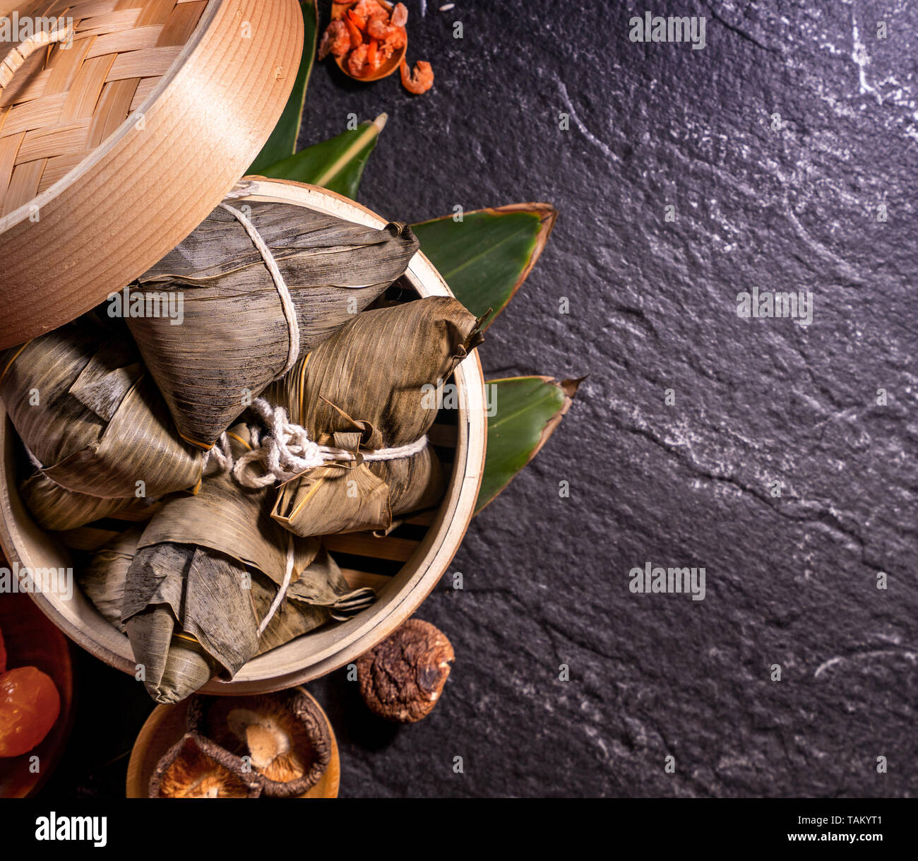 Zongzi, delicious steamed rice dumplings in steamer in black background ...