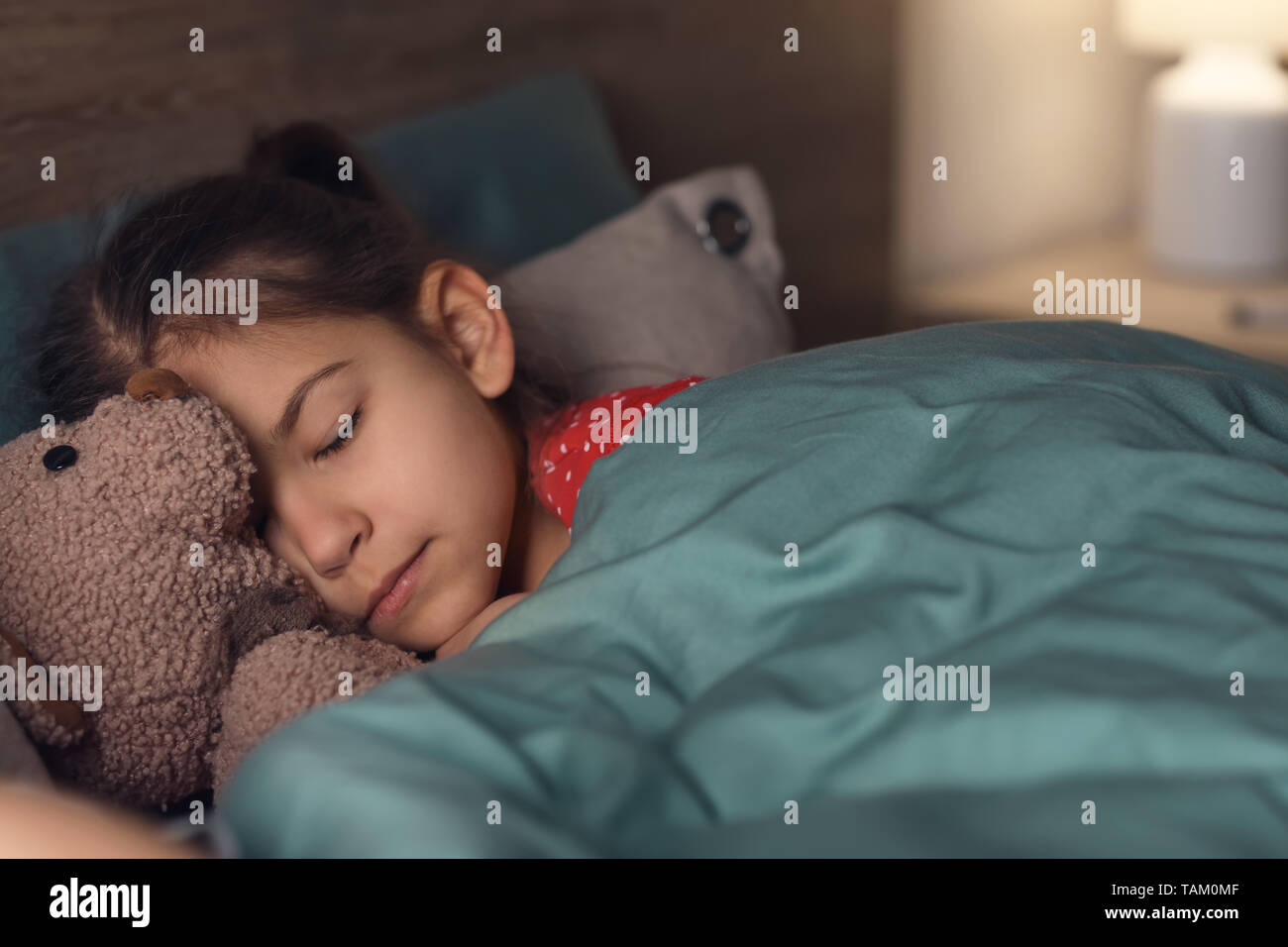 Cute sleeping girl with teddy bear in bed at home Stock Photo - Alamy