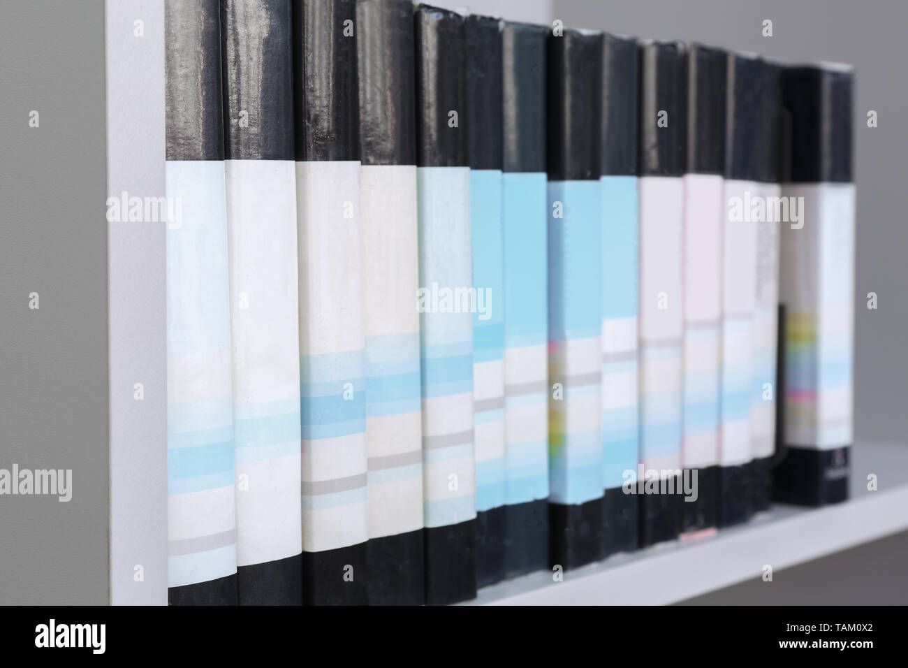 Many books on shelf in modern library Stock Photo - Alamy