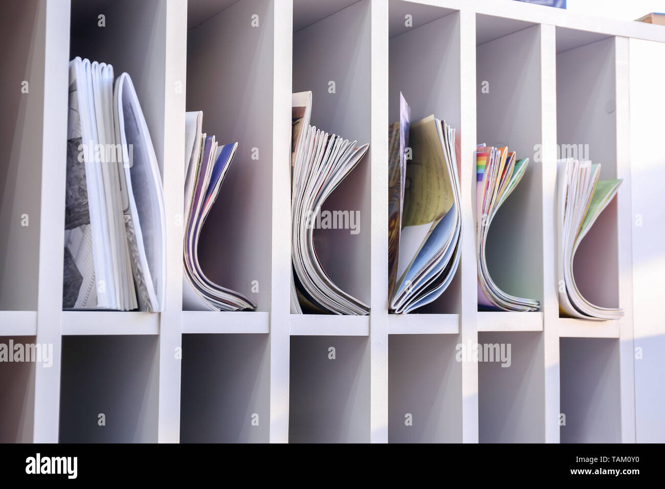 Many magazines on shelves in modern library Stock Photo - Alamy