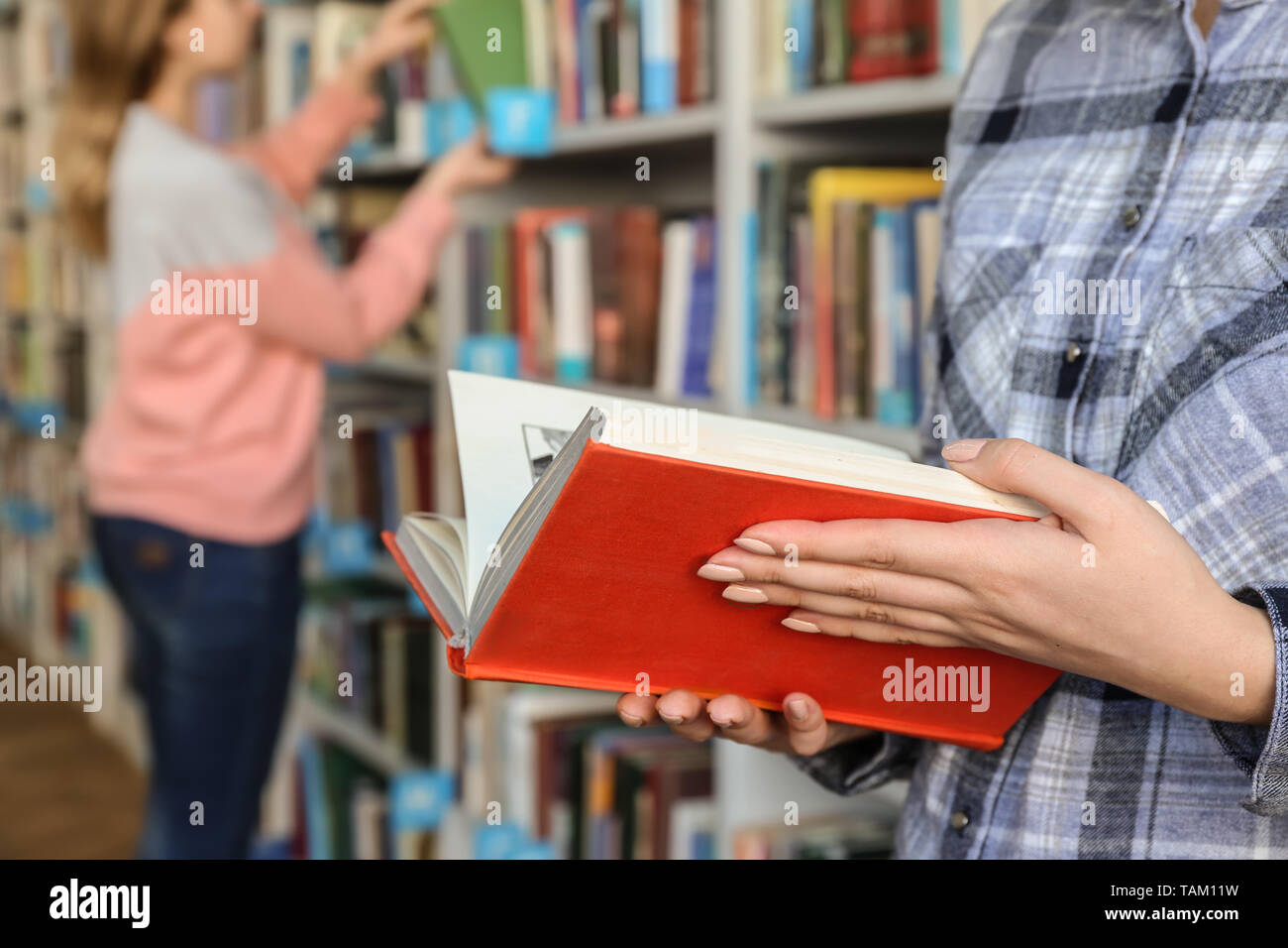 Woman choosing books in store hi-res stock photography and images - Alamy