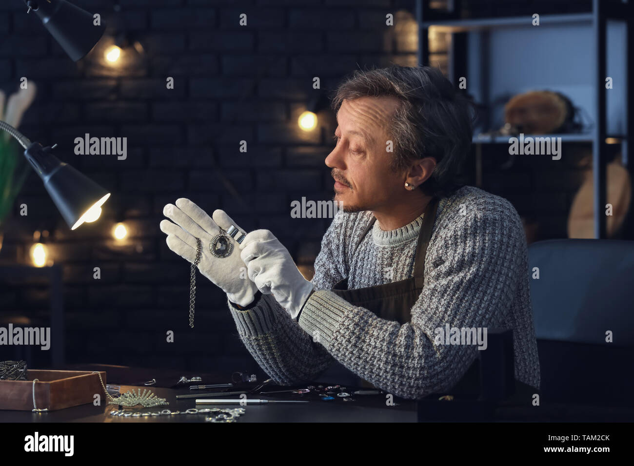 Jeweller making adornment in workshop Stock Photo - Alamy