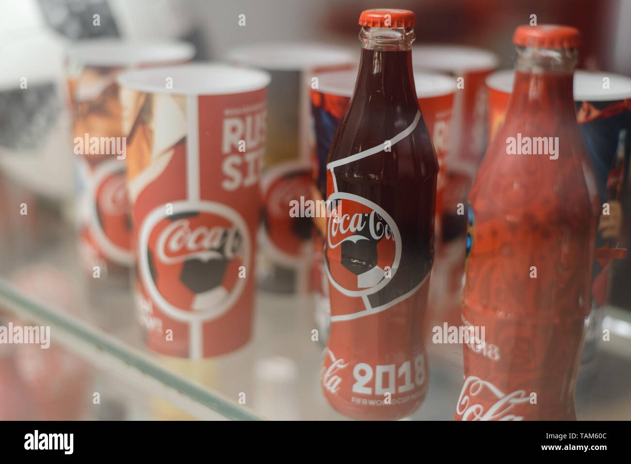 glass bottle of coca cola behind the showcase Stock Photo - Alamy