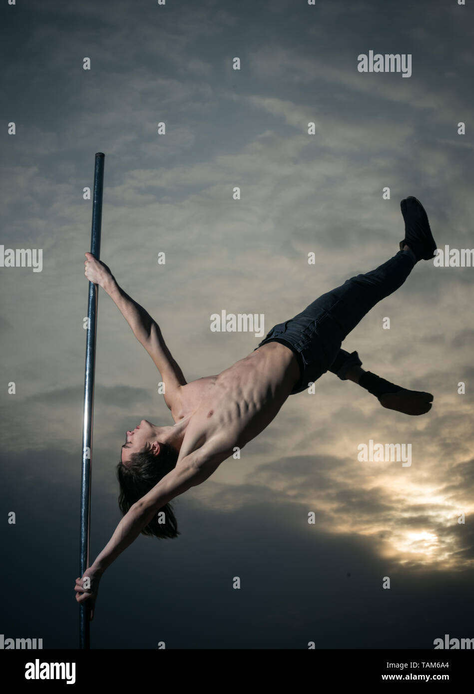 sunset pole dancer. sunset sky with man dancing on pylon Stock Photo ...