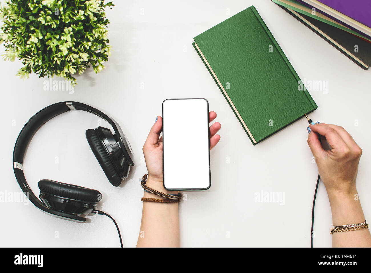 Flat lay. Books and headphones connected to them on a white background ...
