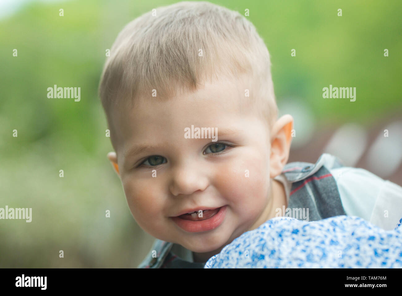 Toddler boy smiling with baby teeth on cute face Stock Photo - Alamy
