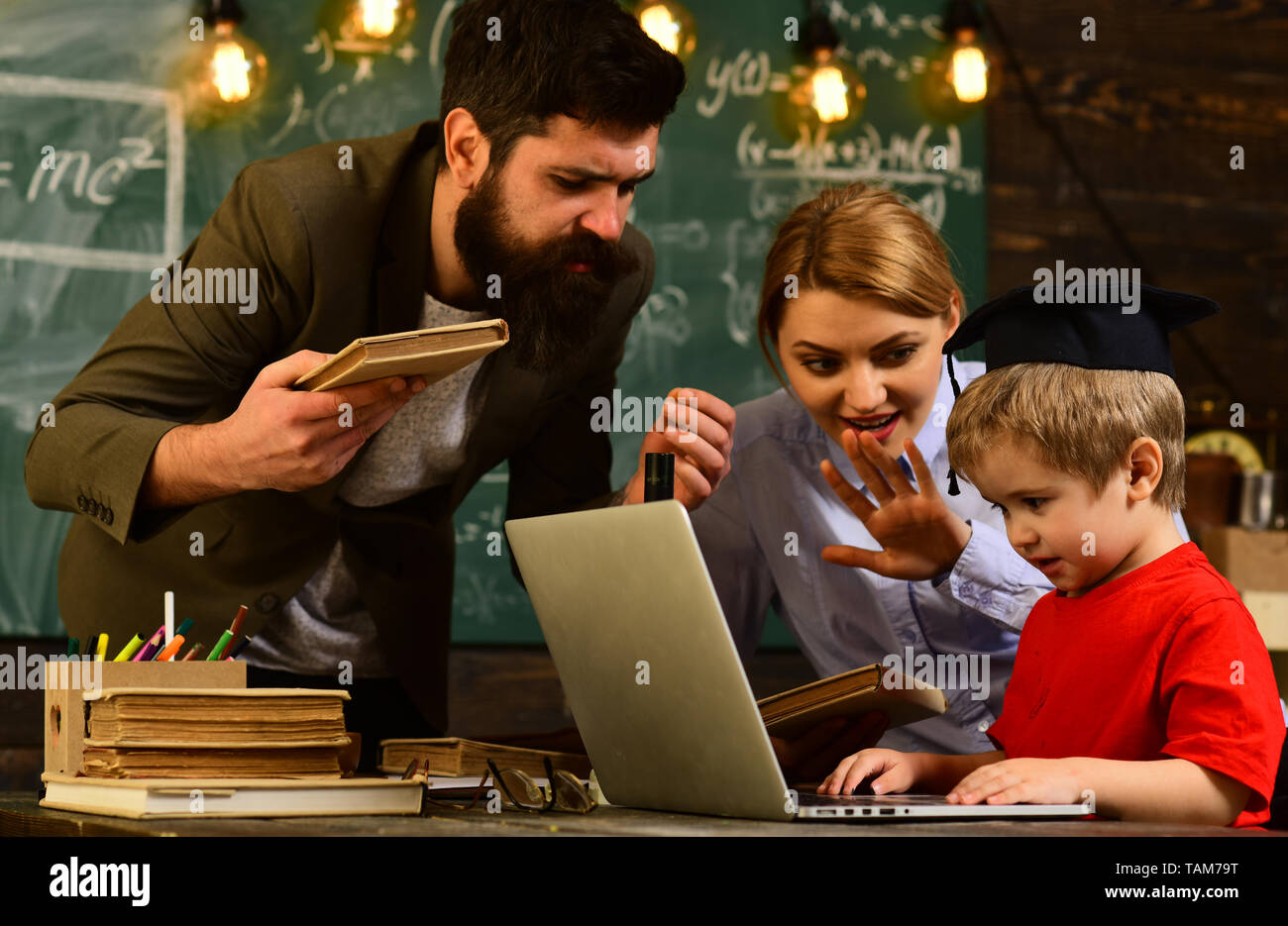 Portrait of female teacher using modern technology laptop in her class ...