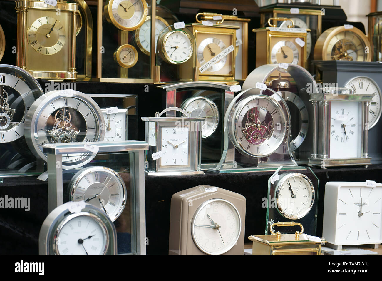 A collection of clocks in store window. Winchester, Hampshire, UK Stock ...