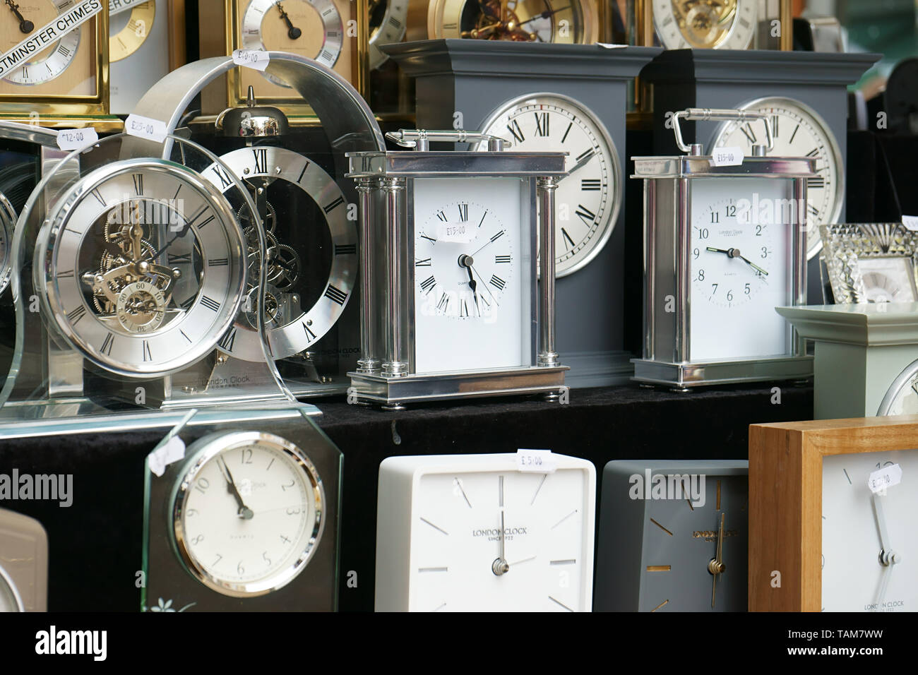 A collection of clocks in store window. Winchester, Hampshire, UK Stock ...