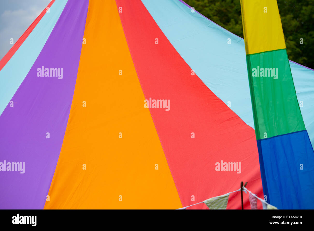 Bright multi-coloured tent and flag Stock Photo - Alamy