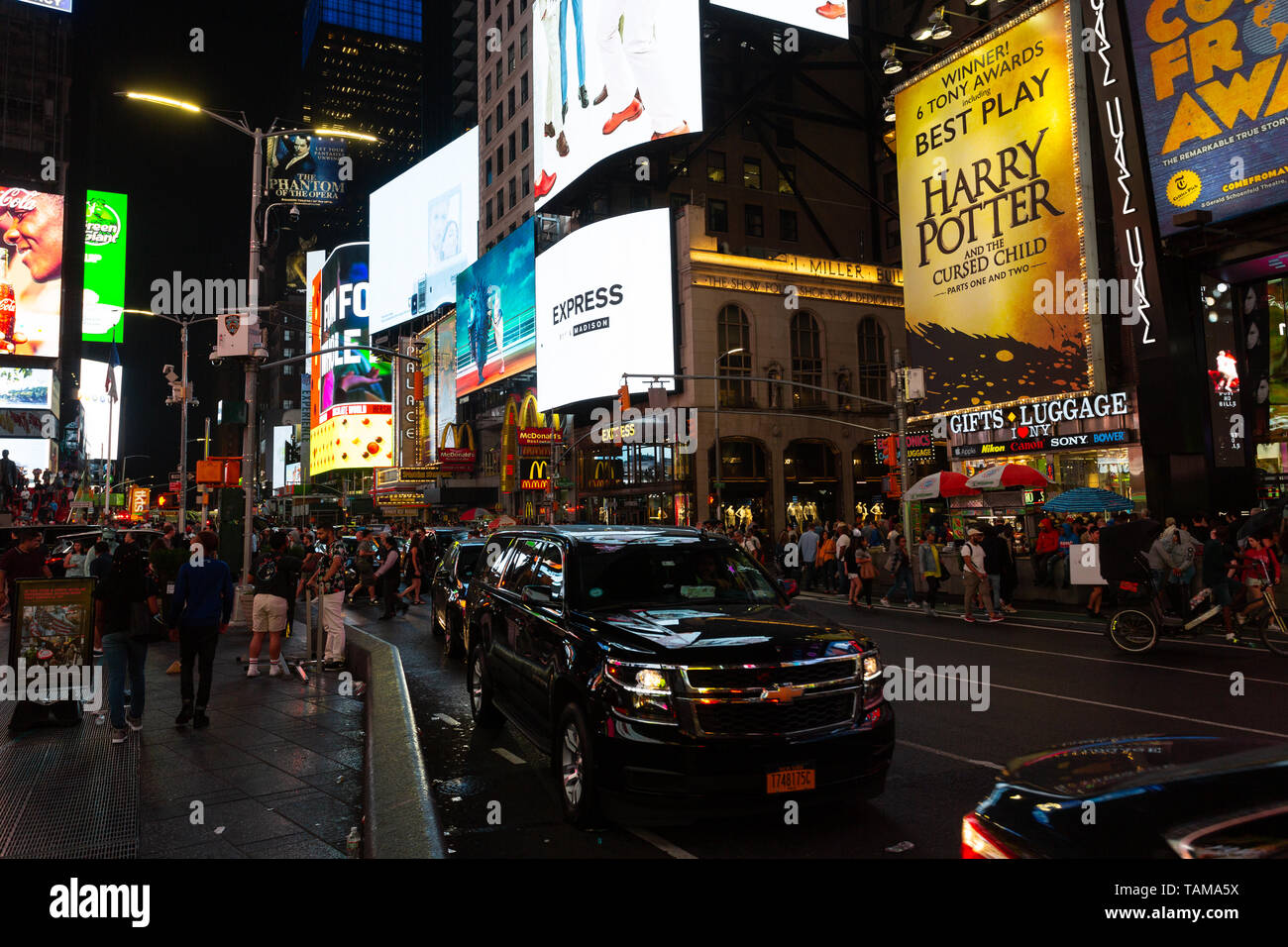 Times Square with lit up billboards at night in the rain - New York ...
