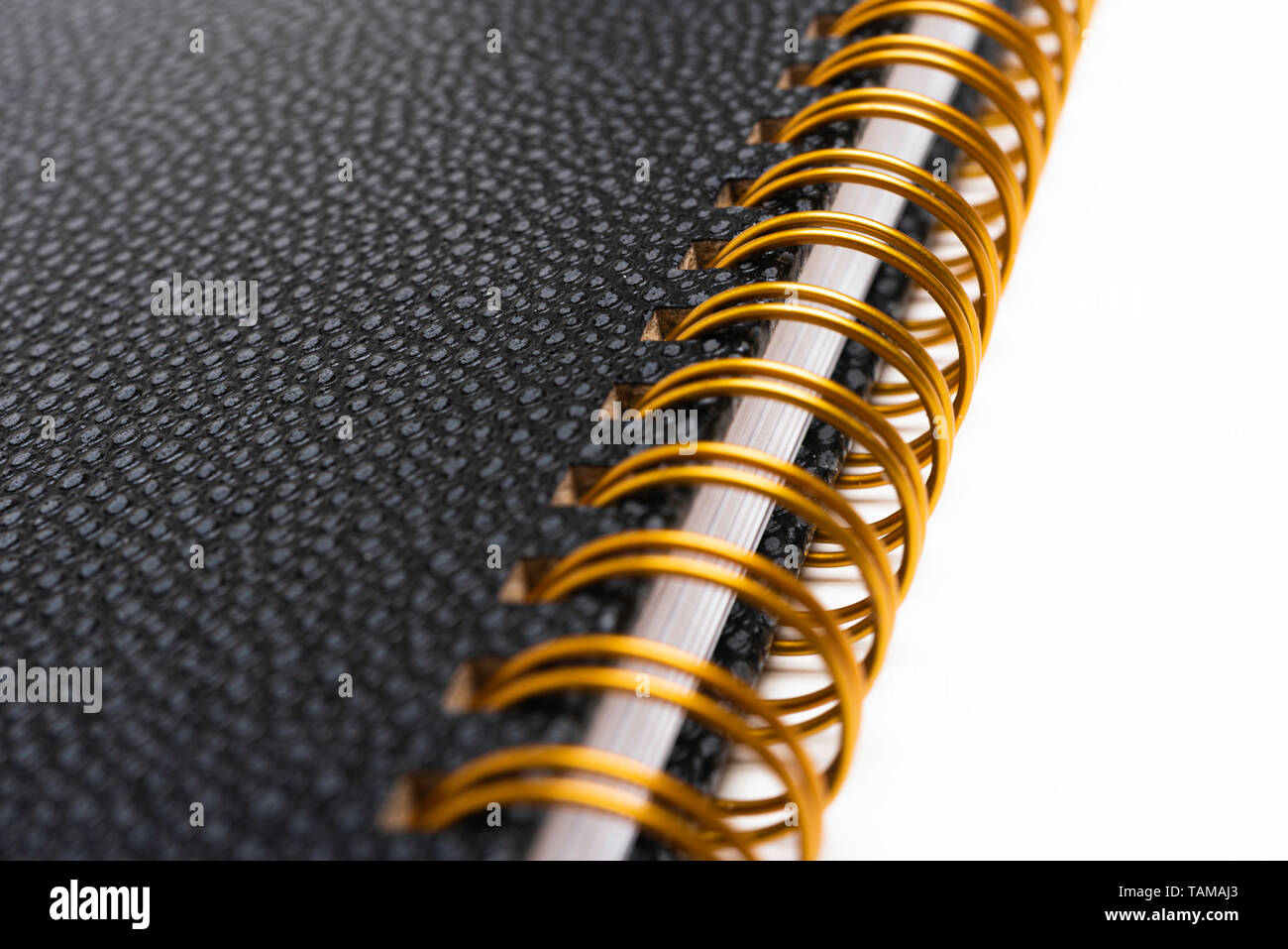 Black faux leather textured notebook cover in a yellowed metal ring ...