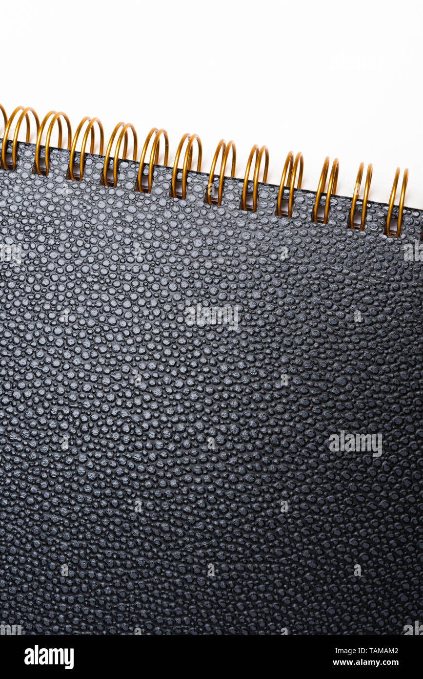 Black faux leather textured notebook cover in a yellowed metal ring ...