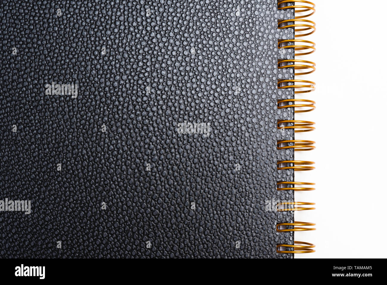 Black faux leather textured notebook cover in a yellowed metal ring ...