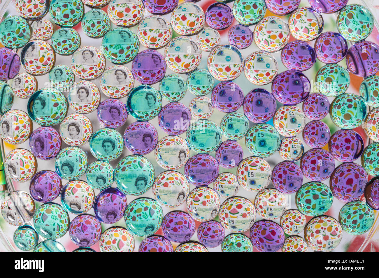 5 pound british note refracted through marble-sized spheres as ...