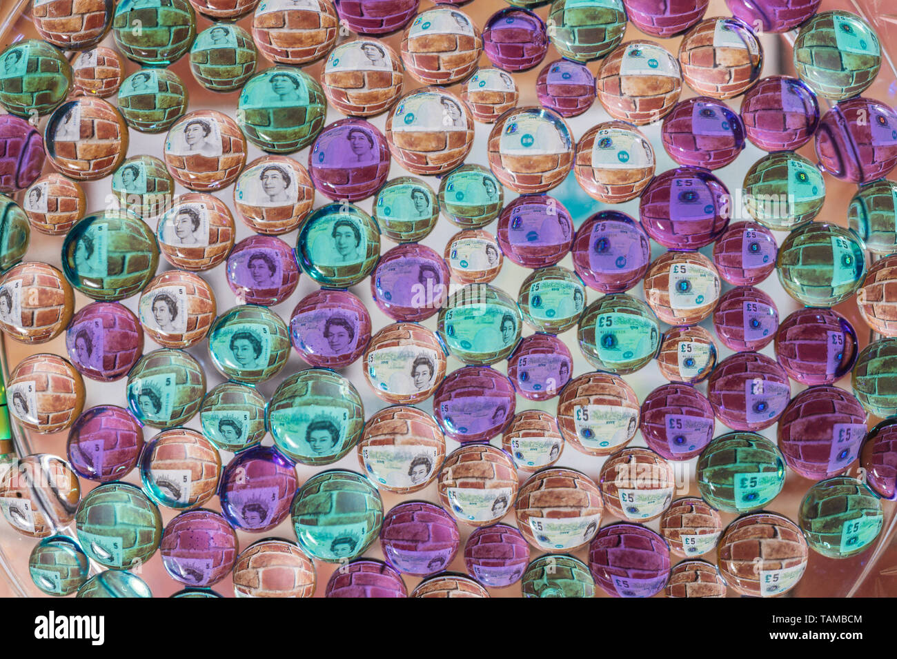 5 pound british note refracted through marble-sized spheres as ...